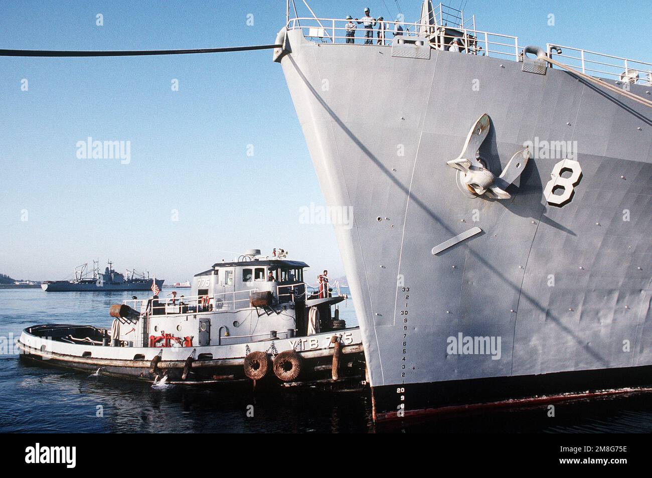The large harbor tug WAUWATOSA (YTB-775) maneuvers the amphibious ...