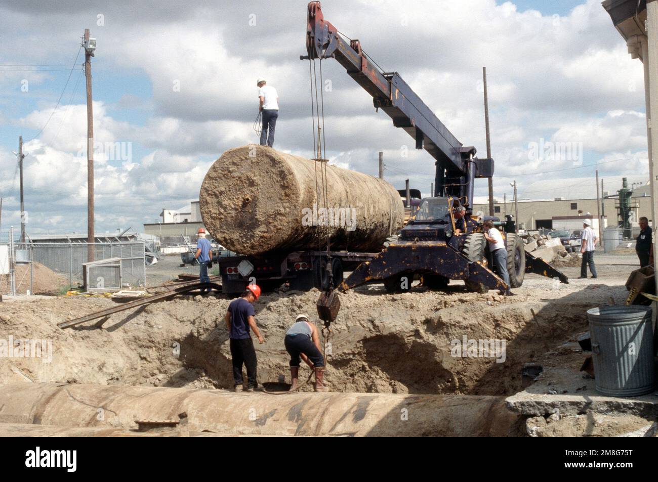 A rusted underground storage tank is unearth for cleaning and recycling ...