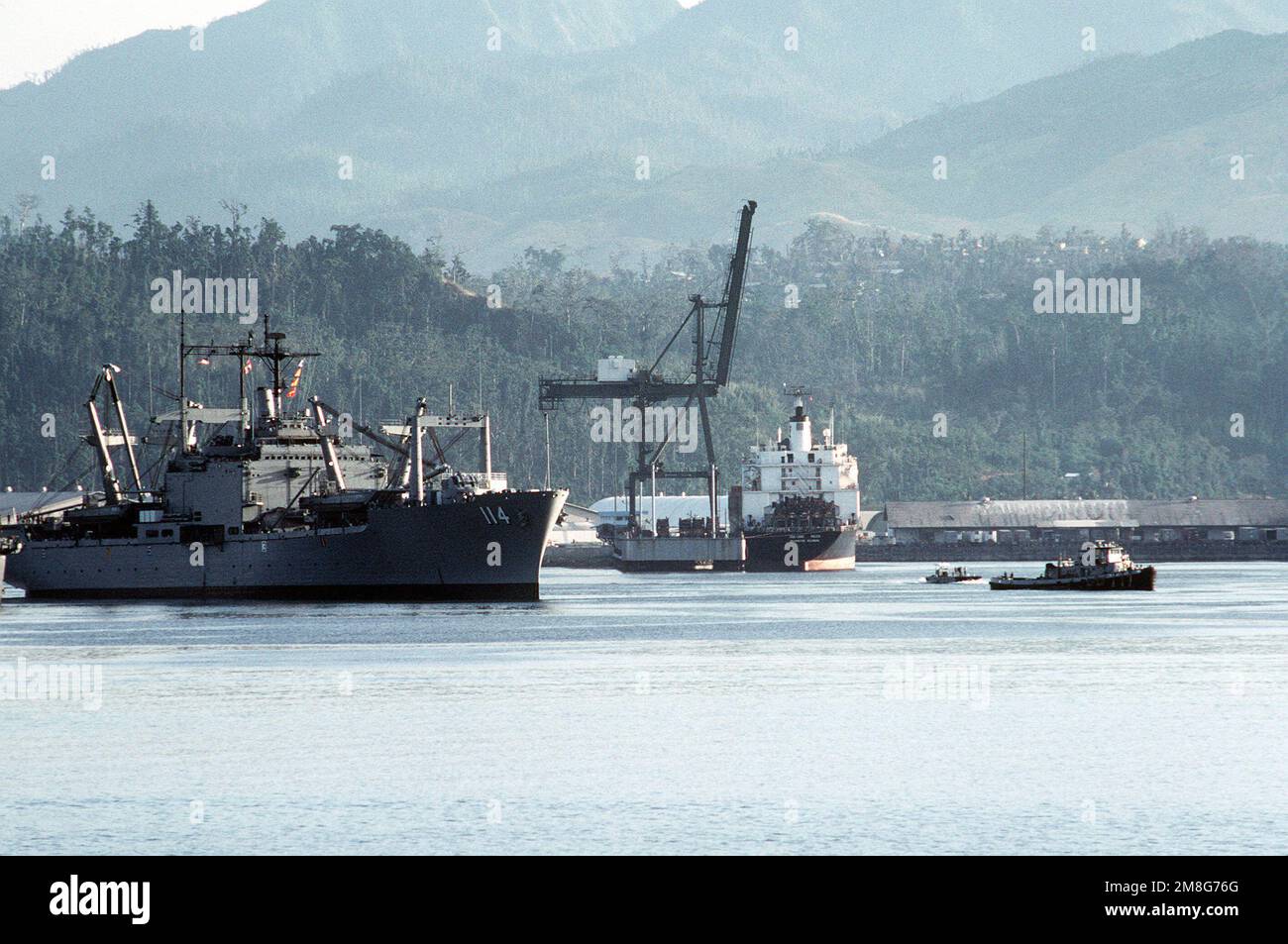 The large harbor tug WAUWATOSA (YTB-775) escorts the amphibious cargo ...