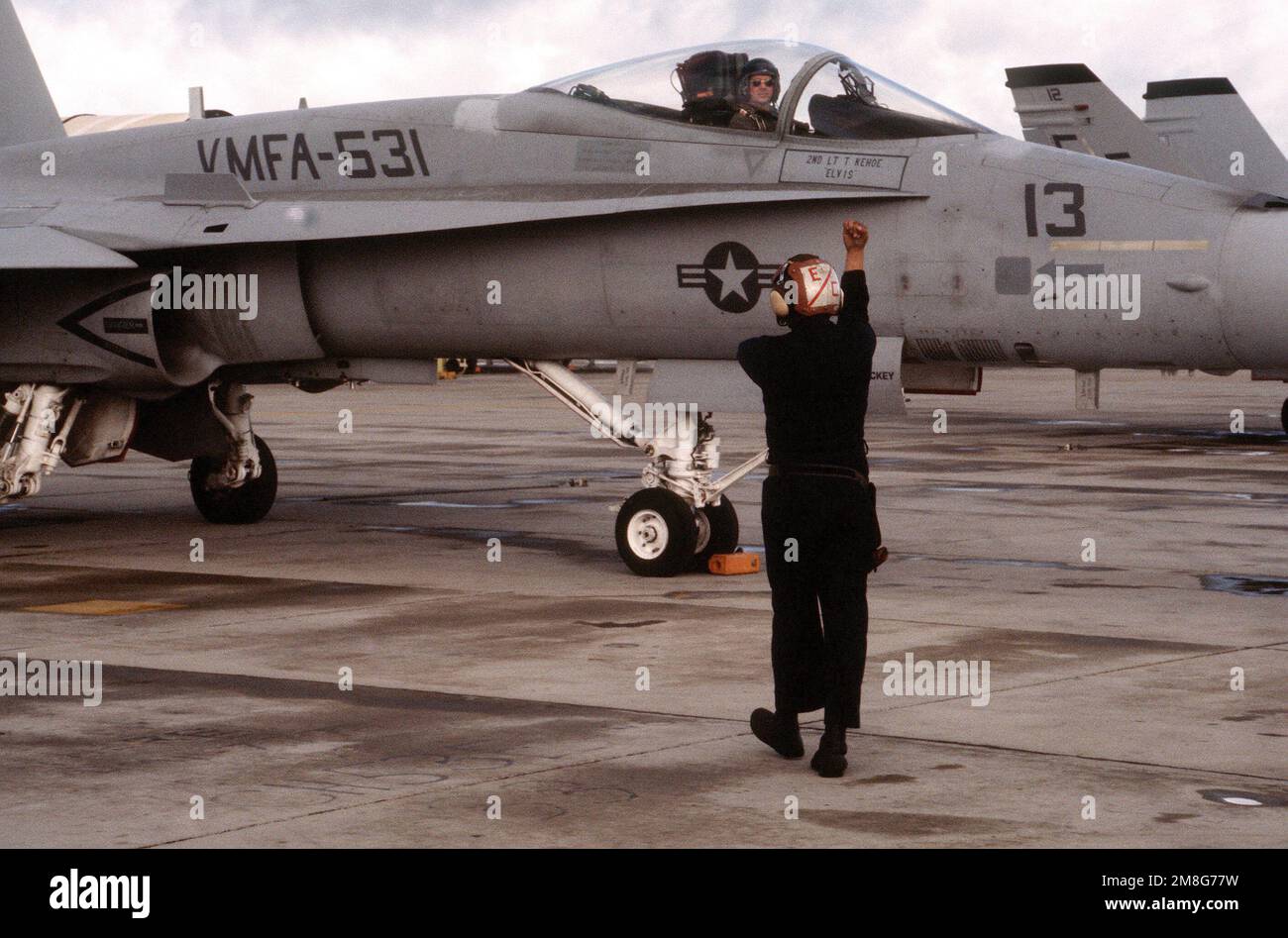 PFC Dwayne Dickey, plane captain, signals to 2LT T. Kehoe, the pilot of ...