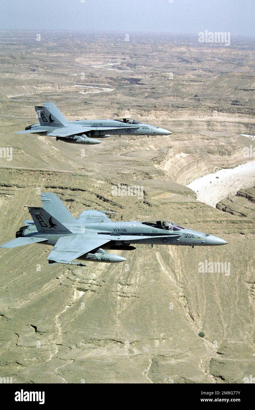 An air-to-air, right side view of two F/A-18C Hornet aircraft from ...
