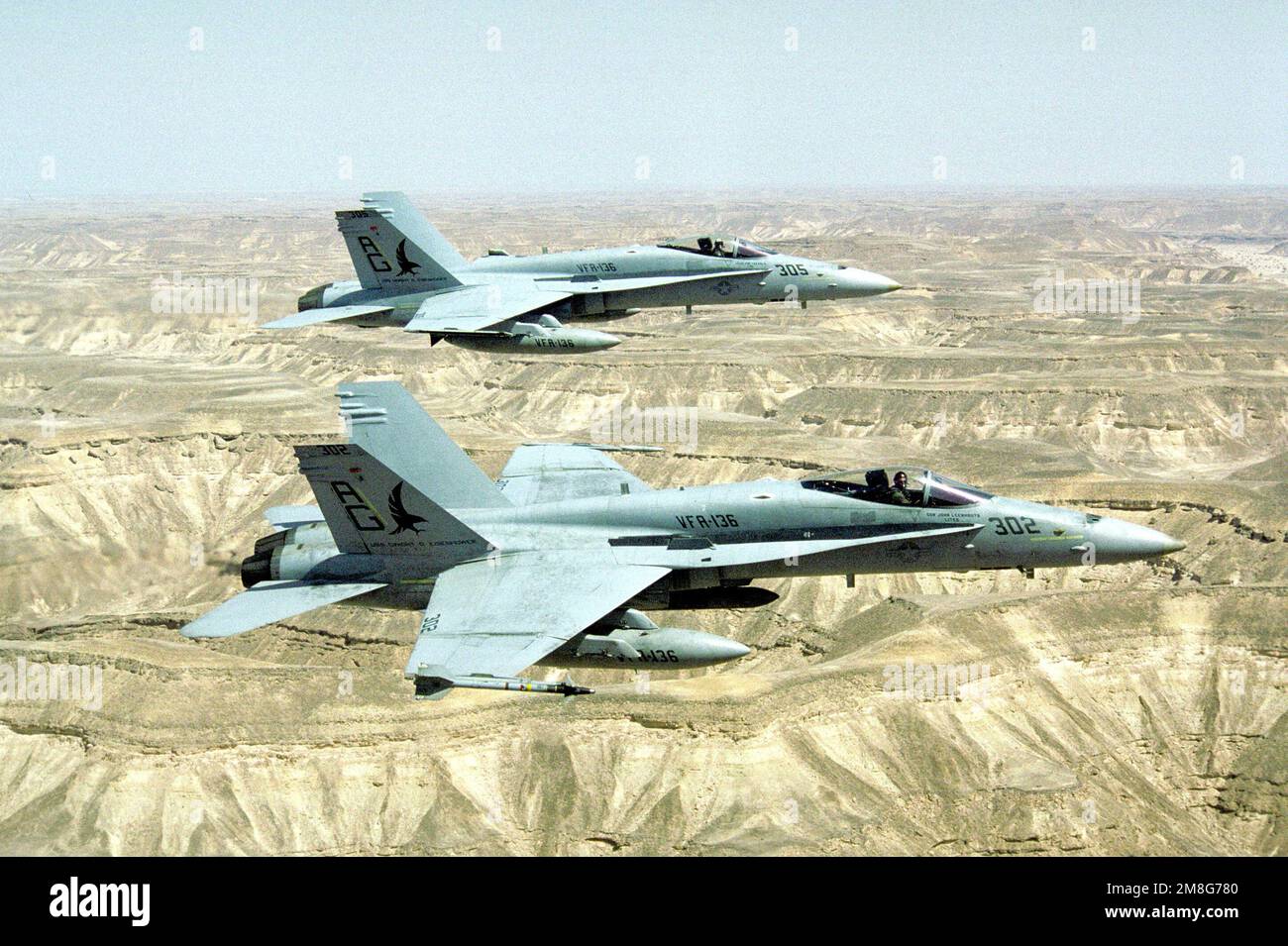 An air-to-air, right side view of two F/A-18C Hornet aircraft from ...