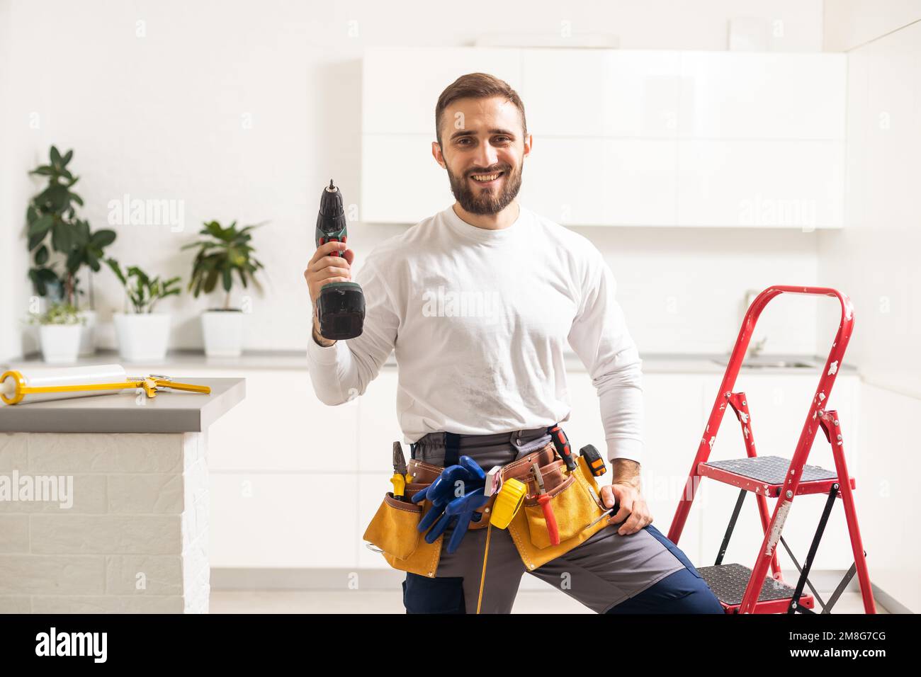 Home repairs. Portrait of professional male repairman with metal ladder ...