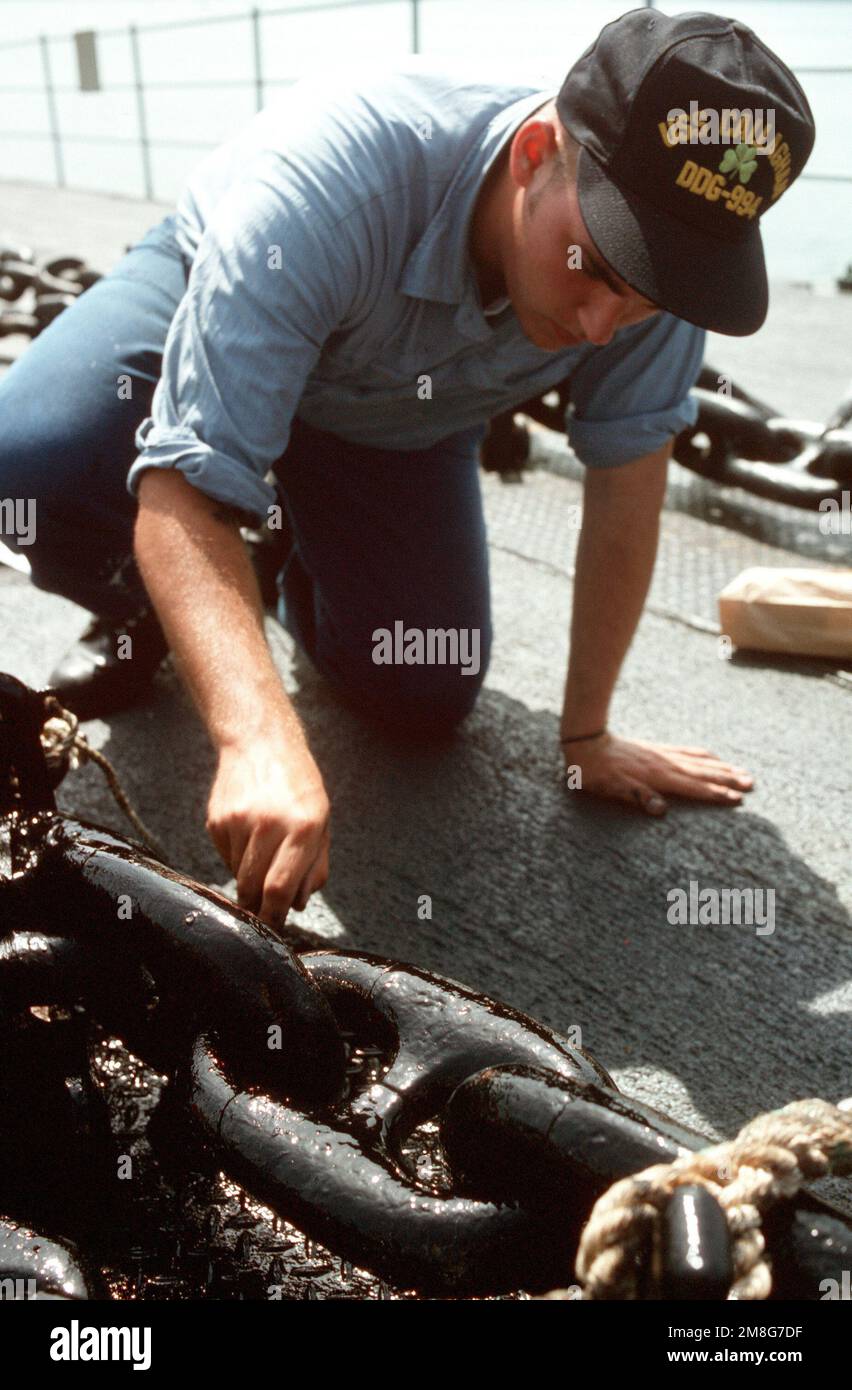 A sailor on the deck of the guided missile destroyer USS CALLAGHAN (DDG ...