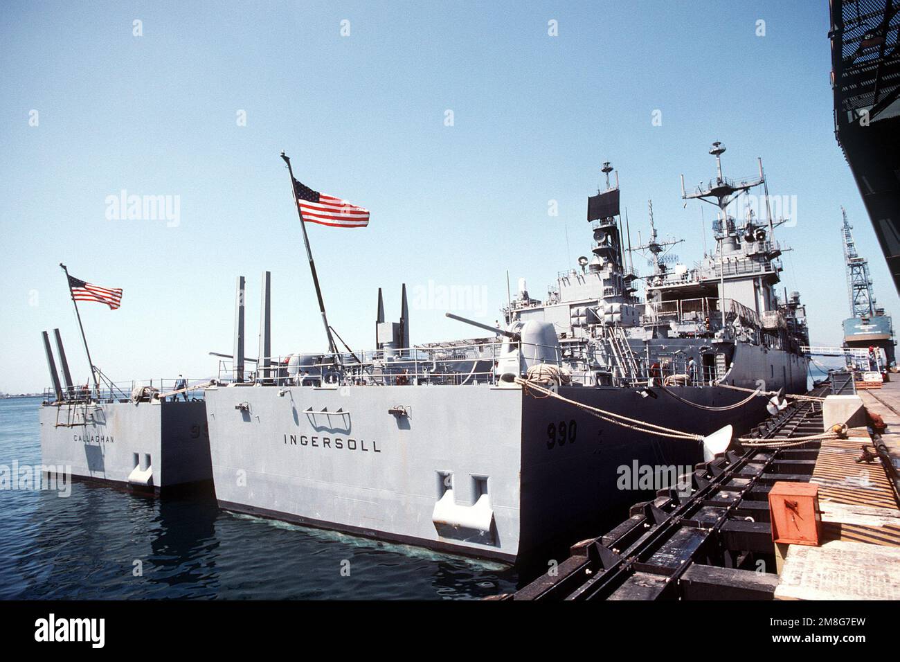 A starboard quarter view of the destroyer USS INGERSOLL (DD-990) and ...