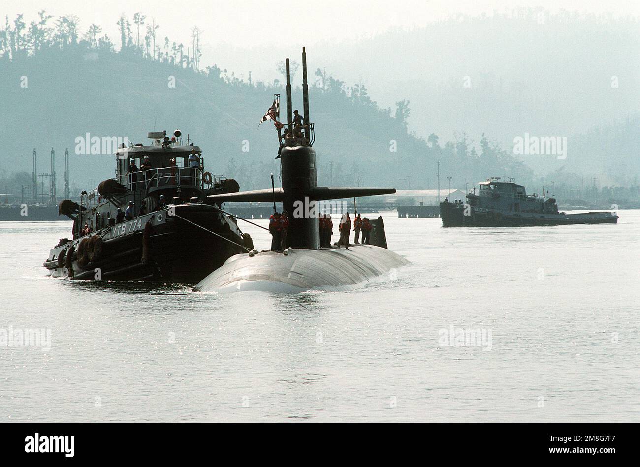 The large harbor tug NASHUA (YTB-774) assists the nuclear-powered ...
