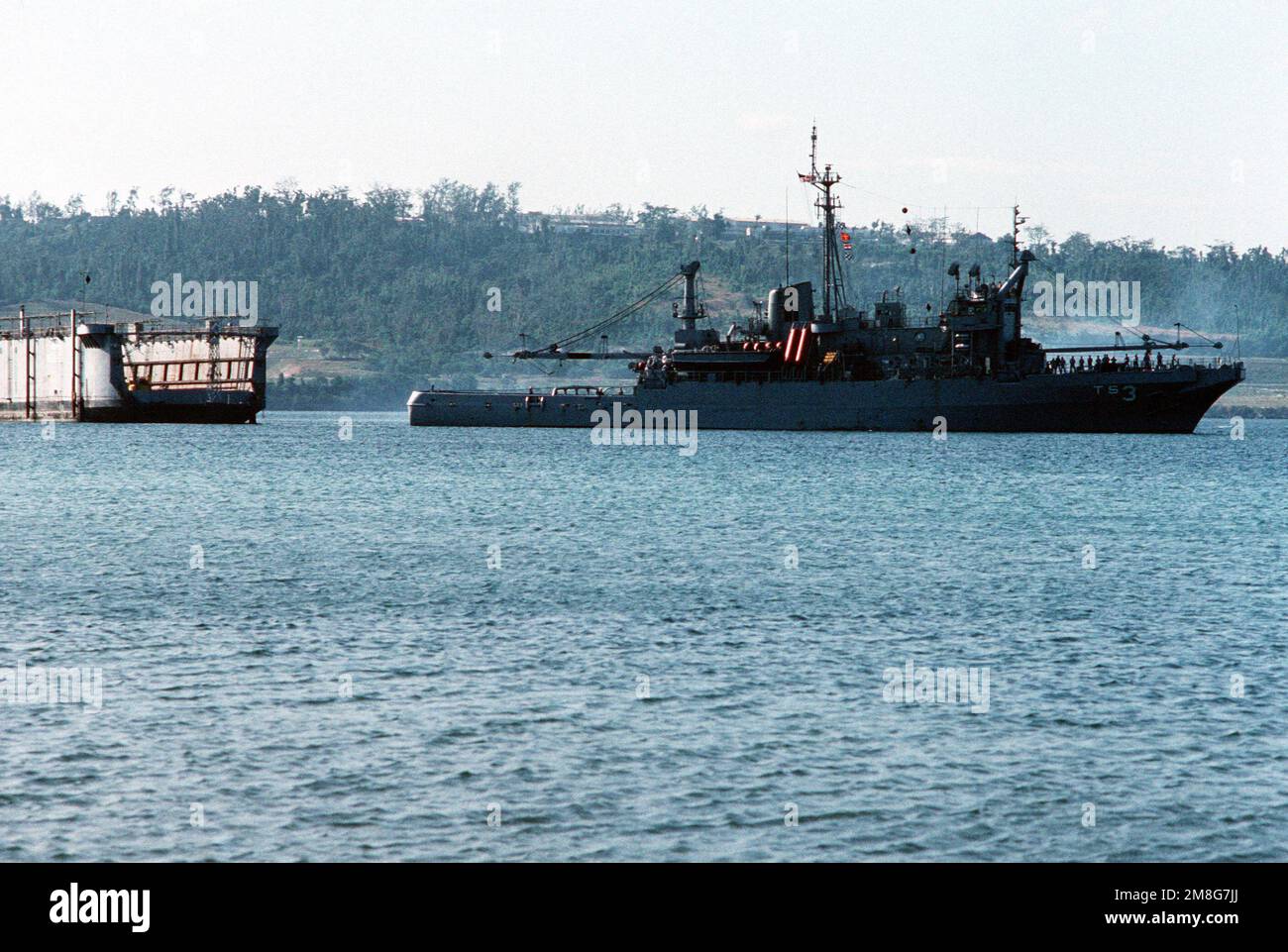 The salvage and rescue ship USS BRUNSWICK (ATS-3) tows the small ...
