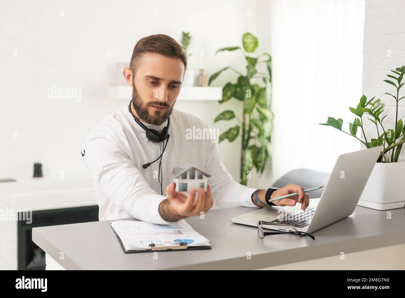 Small toy house in hands Stock Photo - Alamy