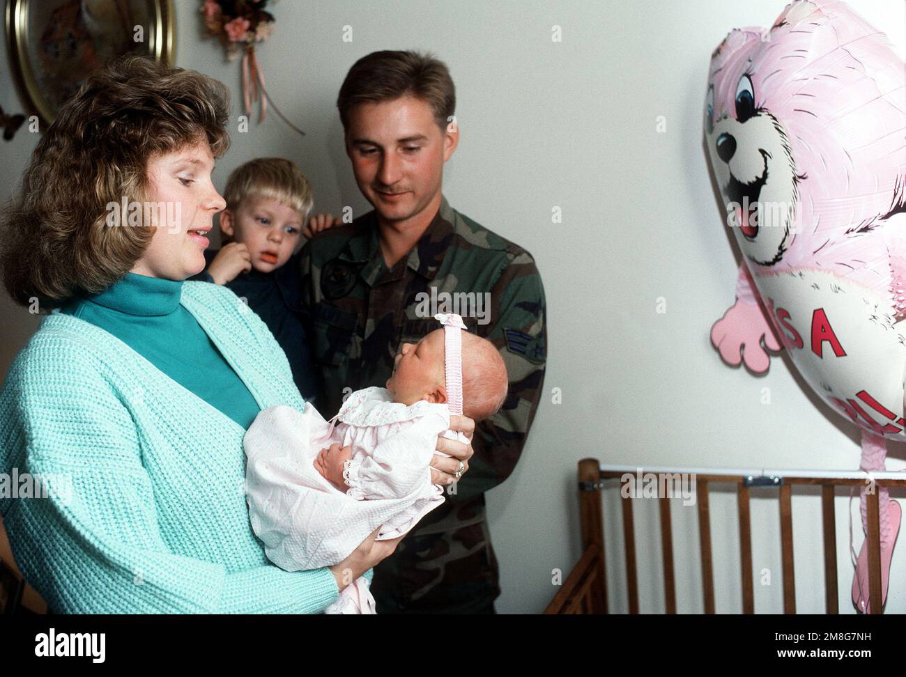 Laura Beams holds 2-day-old daughter Kendall as her husband, SGT. Neal ...