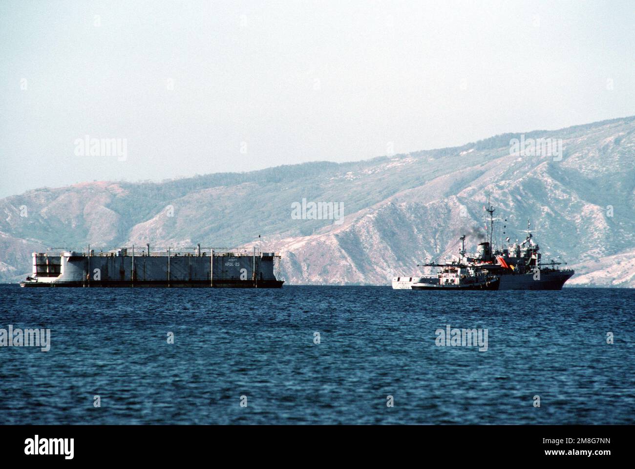The salvage and rescue ship USS BRUNSWICK (ATS-3) tows the small ...