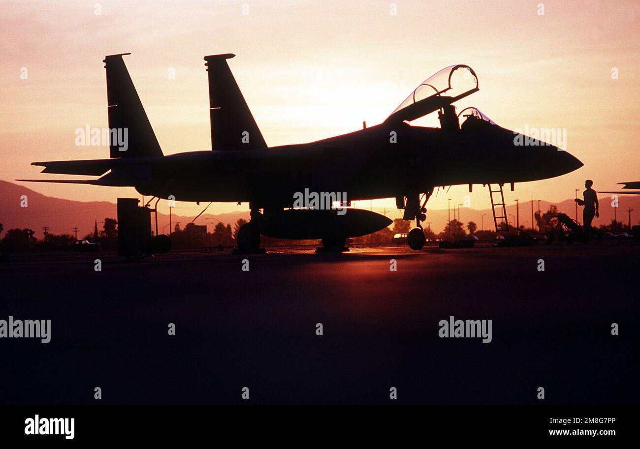 An F-15C Eagle aircraft of the 1ST Tactical Fighter Wing is silhouetted ...