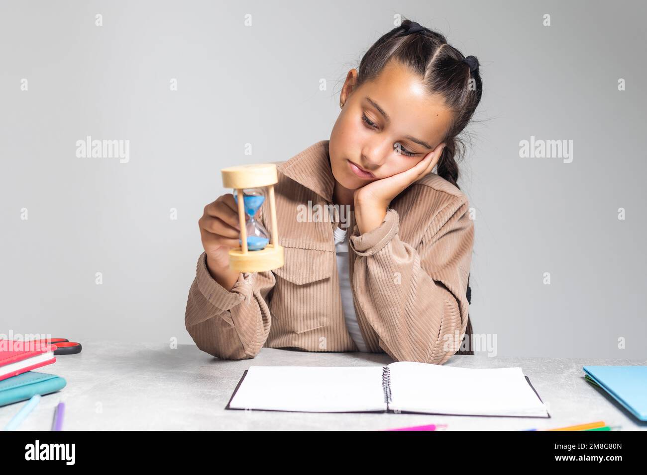 Little cute girl is bored and tired with doing her homework Stock Photo ...