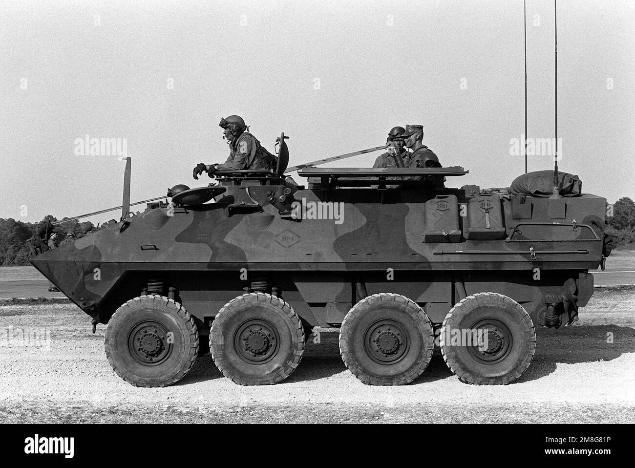 A full side view of a light armored vehicle (LAV) while the crew waits ...