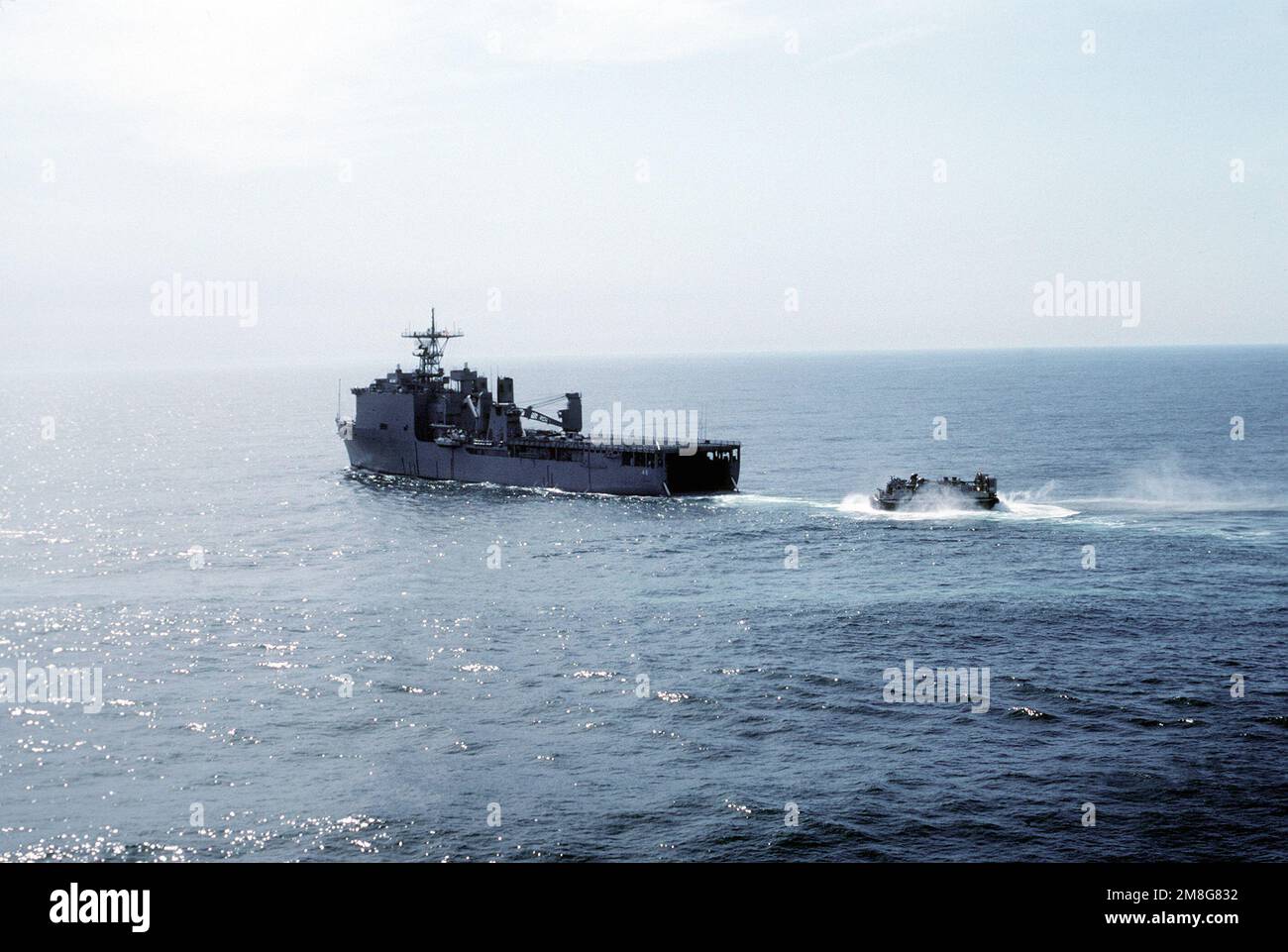 A landing craft air cushion (LCAC) vehicle backs clear of the well deck ...