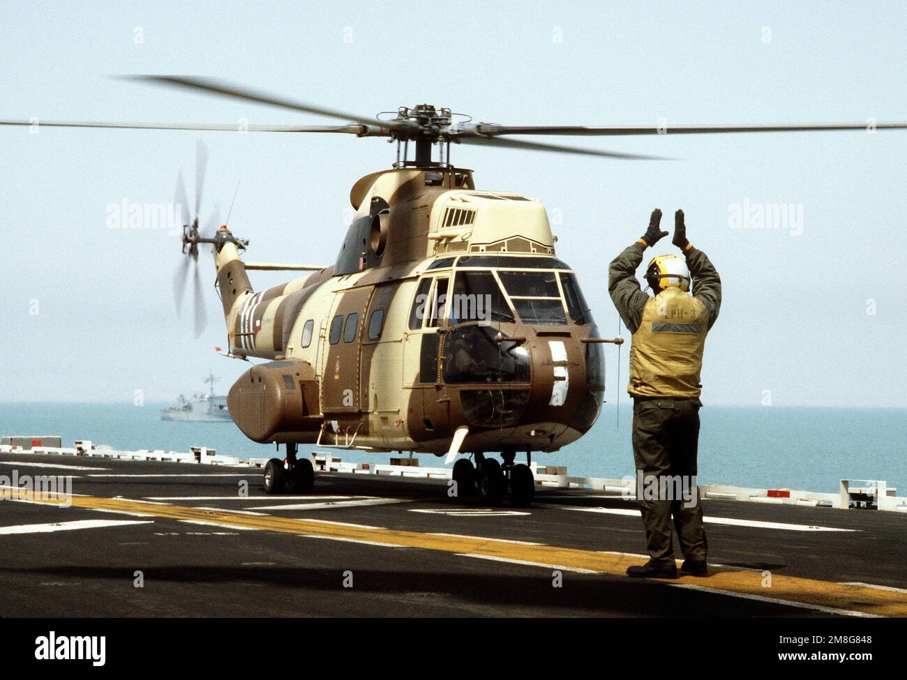 A crew member aboard the amphibious assault ship USS OKINAWA (LPH-3 ...