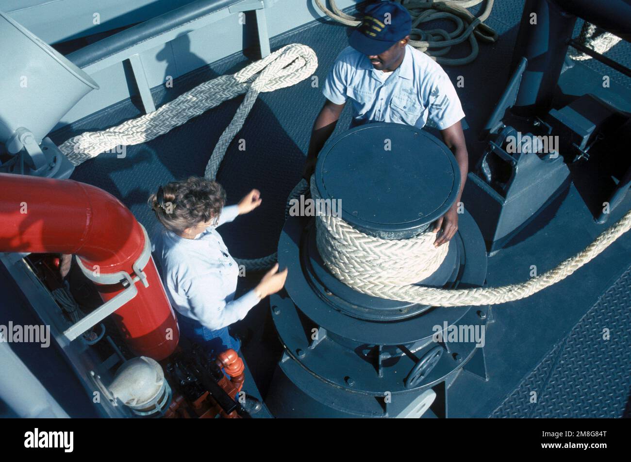 Navy boatswain mates, male and female, on board the large harbor tug ...
