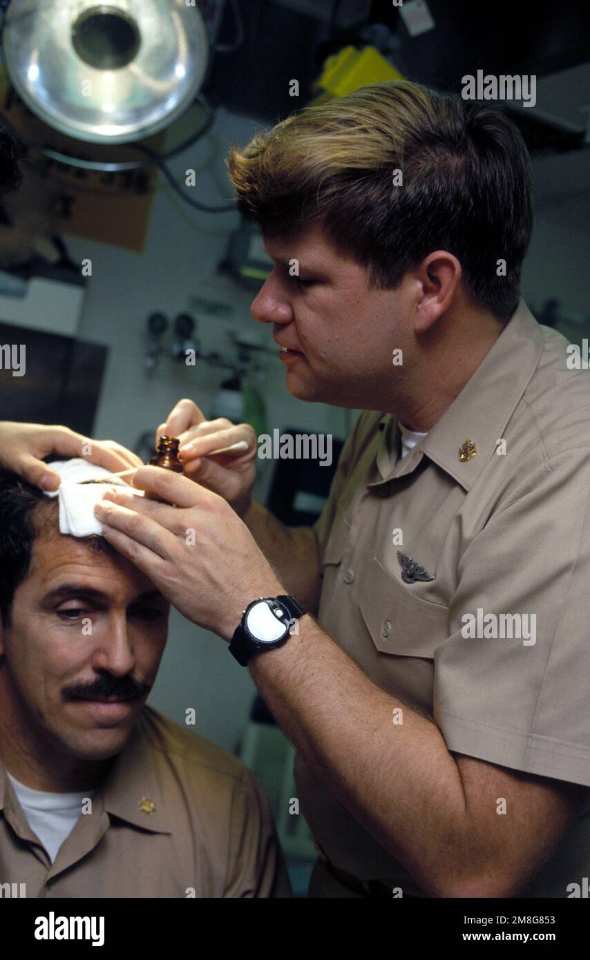 CHIEF Hospital Corpsman (HMC) Overlay treats a cut on the head of CHIEF ...