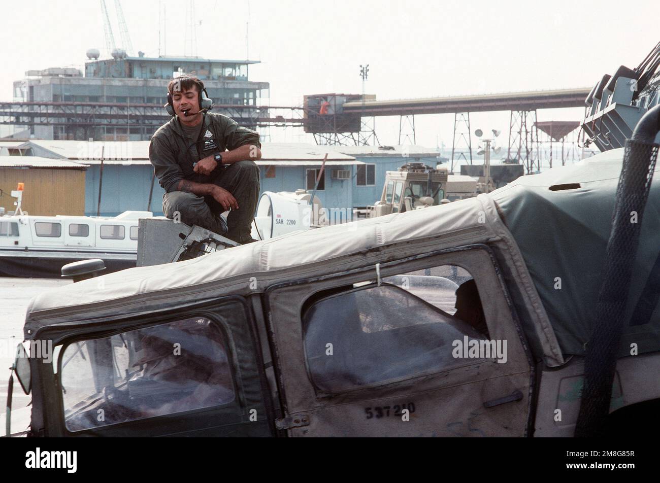 The deck engineer watches as an M998 High-Mobility Multipurpose Wheeled ...