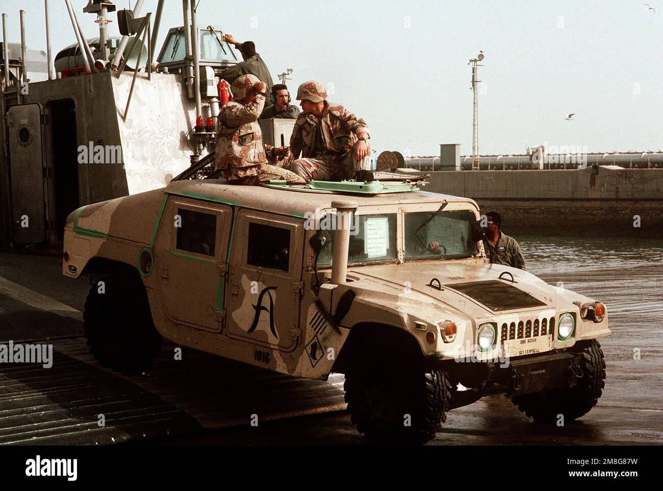 An M-1038 cargo/troop carrier is unloaded from an air-cushioned landing ...