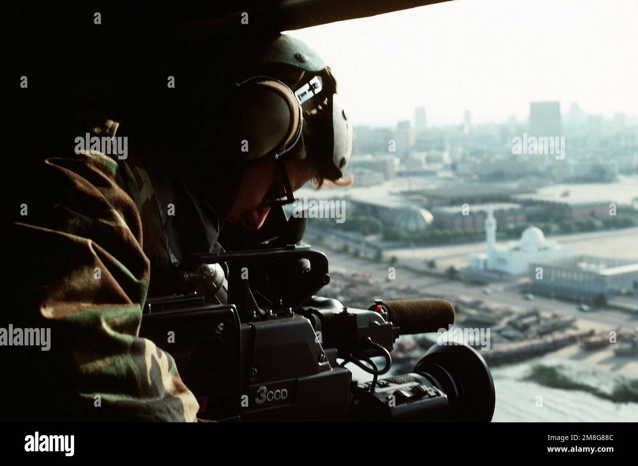 A U.S. military photographer films aerial view of the region from a ...