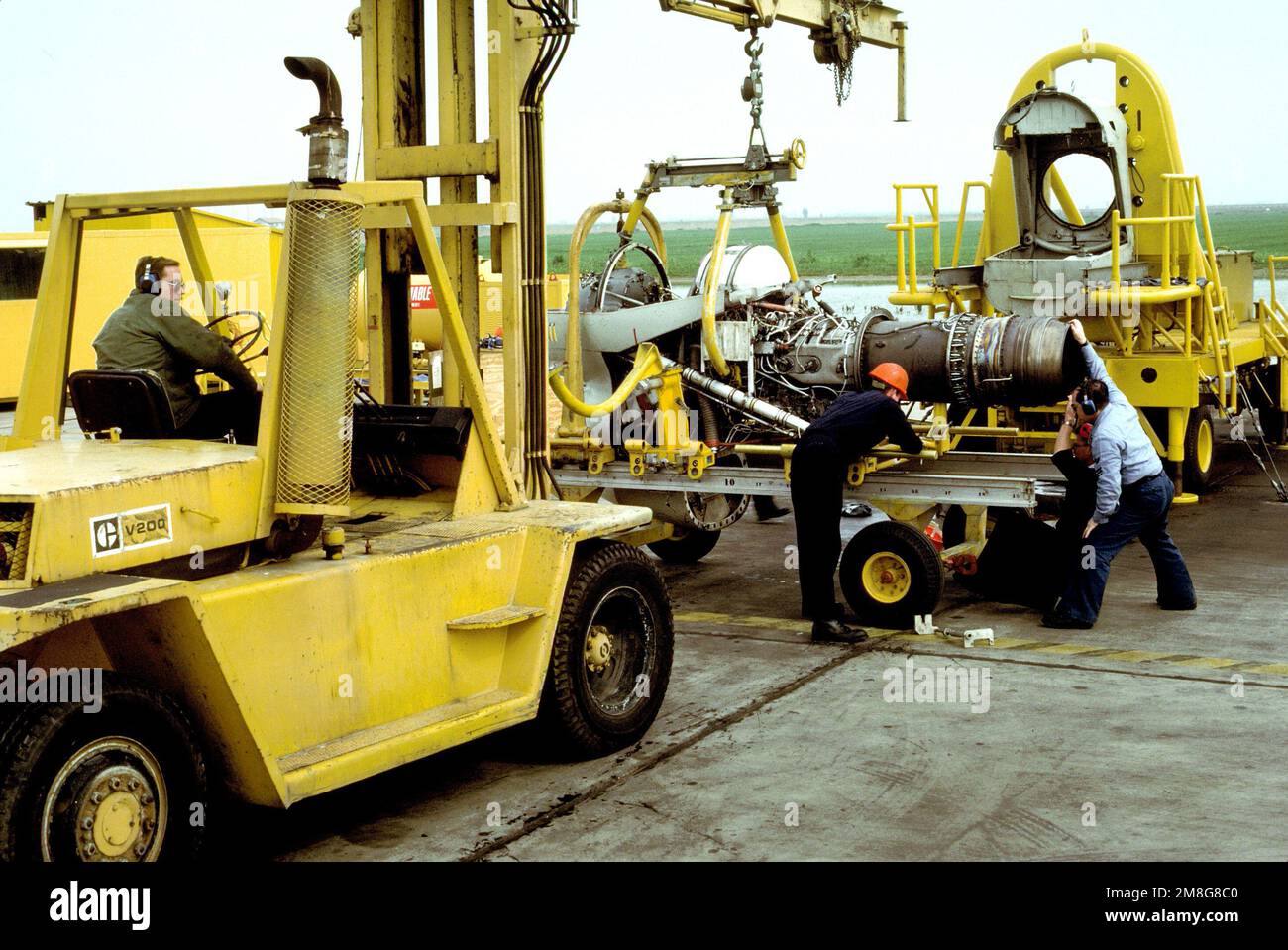 Aviation machinist's mates make final adjustments on an aircraft engine ...