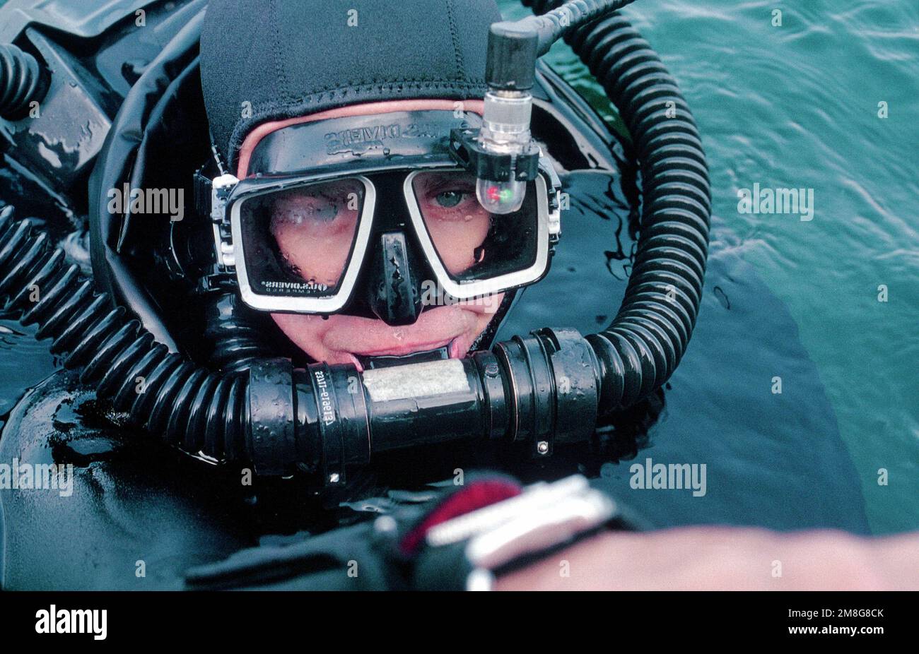 A member of Basic Underwater Demolition/Sea-Air-Land (BUD/S) Class 183 prepares for a dive. Base ...