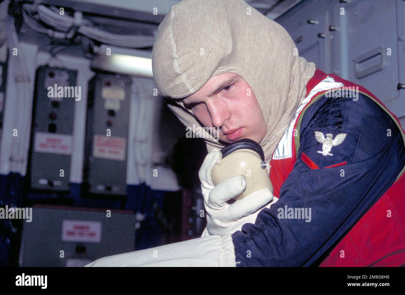 A petty officer communicates information during a general quarters ...