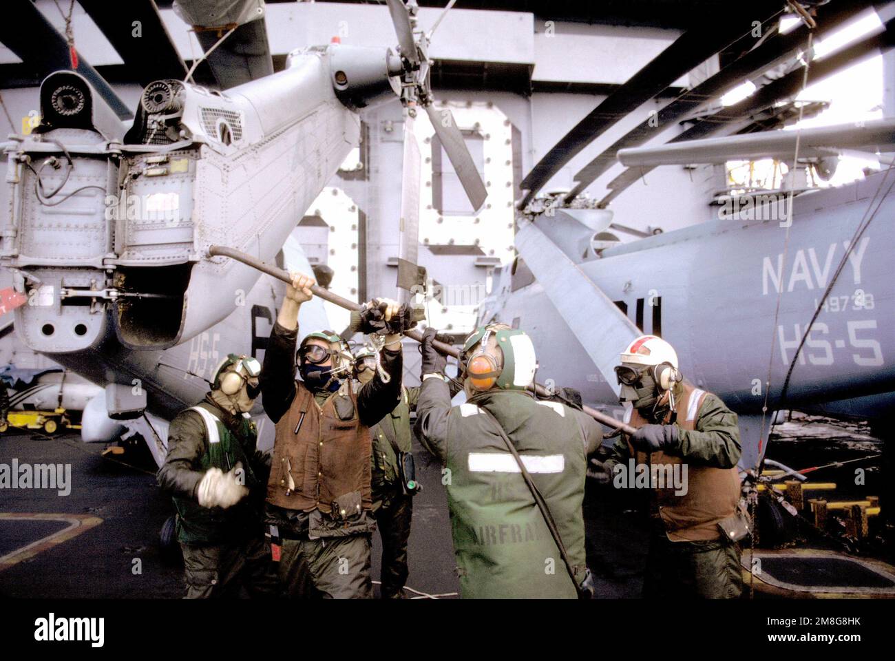 Flight deck crewmen on the nuclear-powered aircraft carrier USS DWIGHT ...
