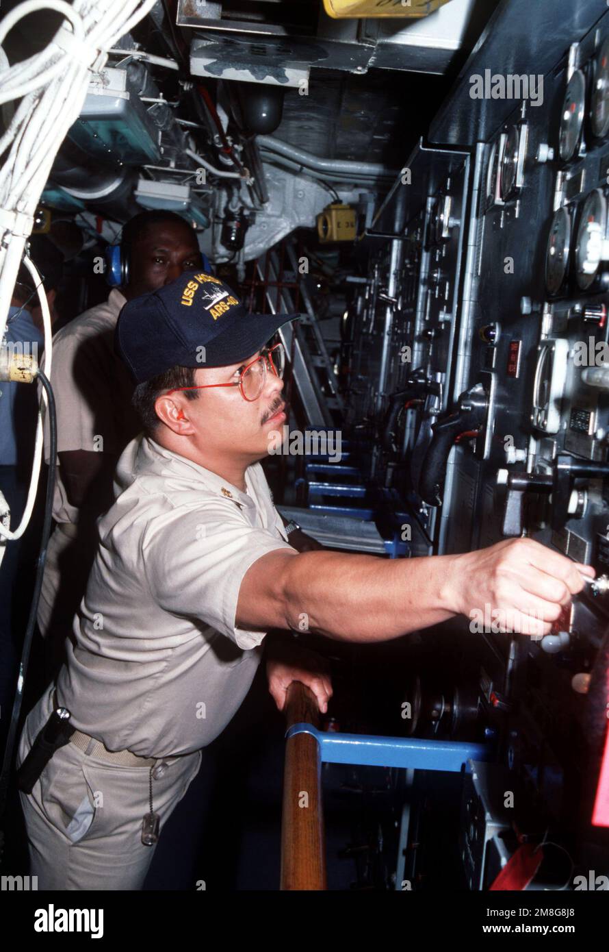 CHIEF Ramos, engineering officer of the day, makes adjustments on the ...