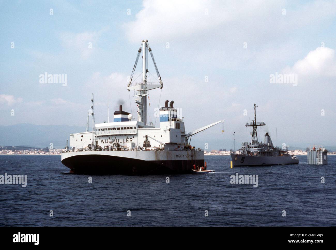 The mine countermeasure ship USS GUARDIAN (MCM-5) is loaded above the ...