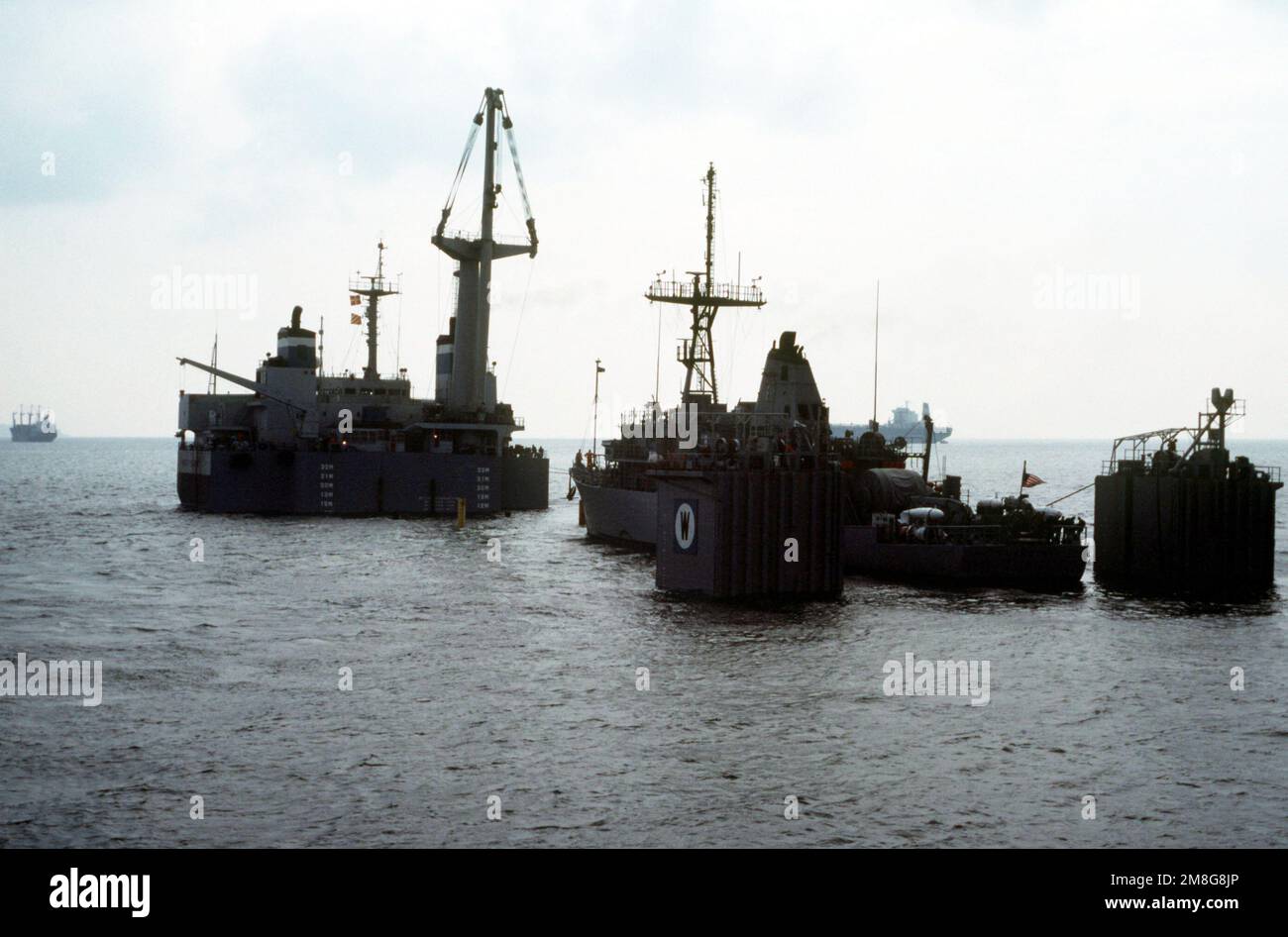 The mine countermeasure ship USS GUARDIAN (MCM-5) is loaded above the ...