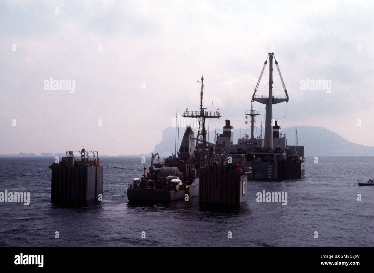 The mine countermeasure ship USS GUARDIAN (MCM-5) is loaded above the ...