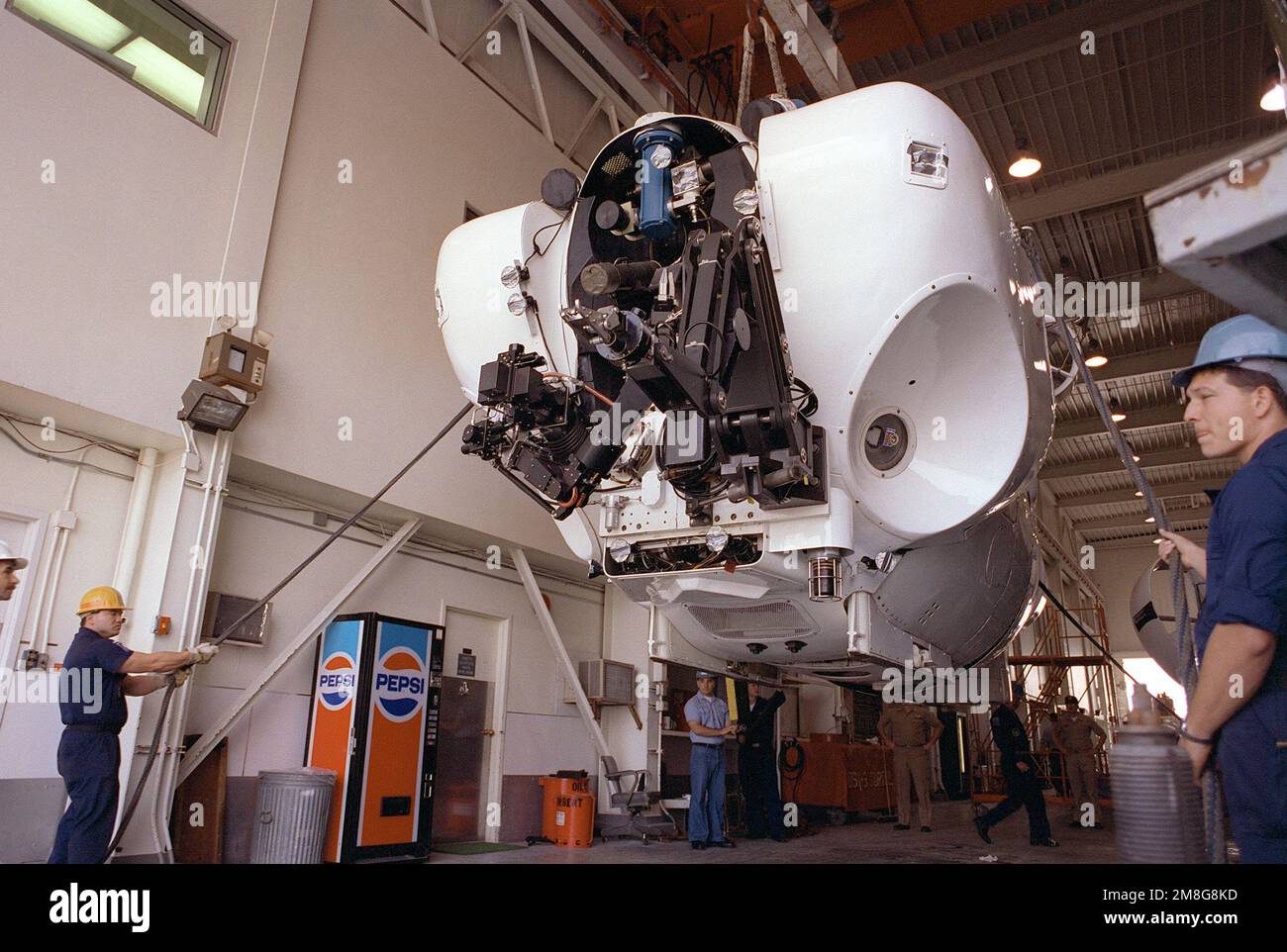 U. S. Navy personnel at the Deep Submergence Unit stabilize the deep submergence vehicle Turtle ...