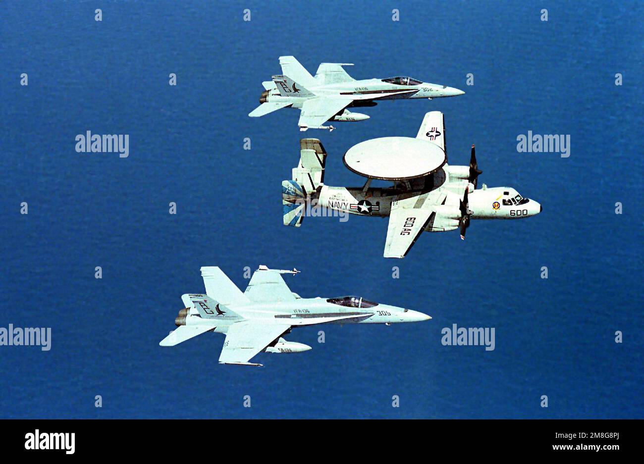 An air-to-air right side view of two Strike Fighter Squadron 136 (VFA ...