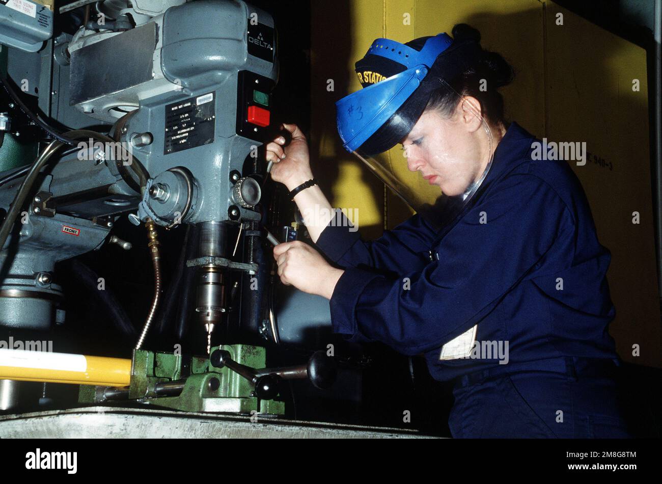 Aviation Support Equipment Technician AIRMAN Campbell drills a hole for ...