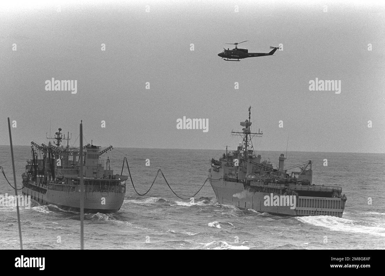 The dock landing ship USS PENSACOLA (LSD-38) Is shown alongside the ...