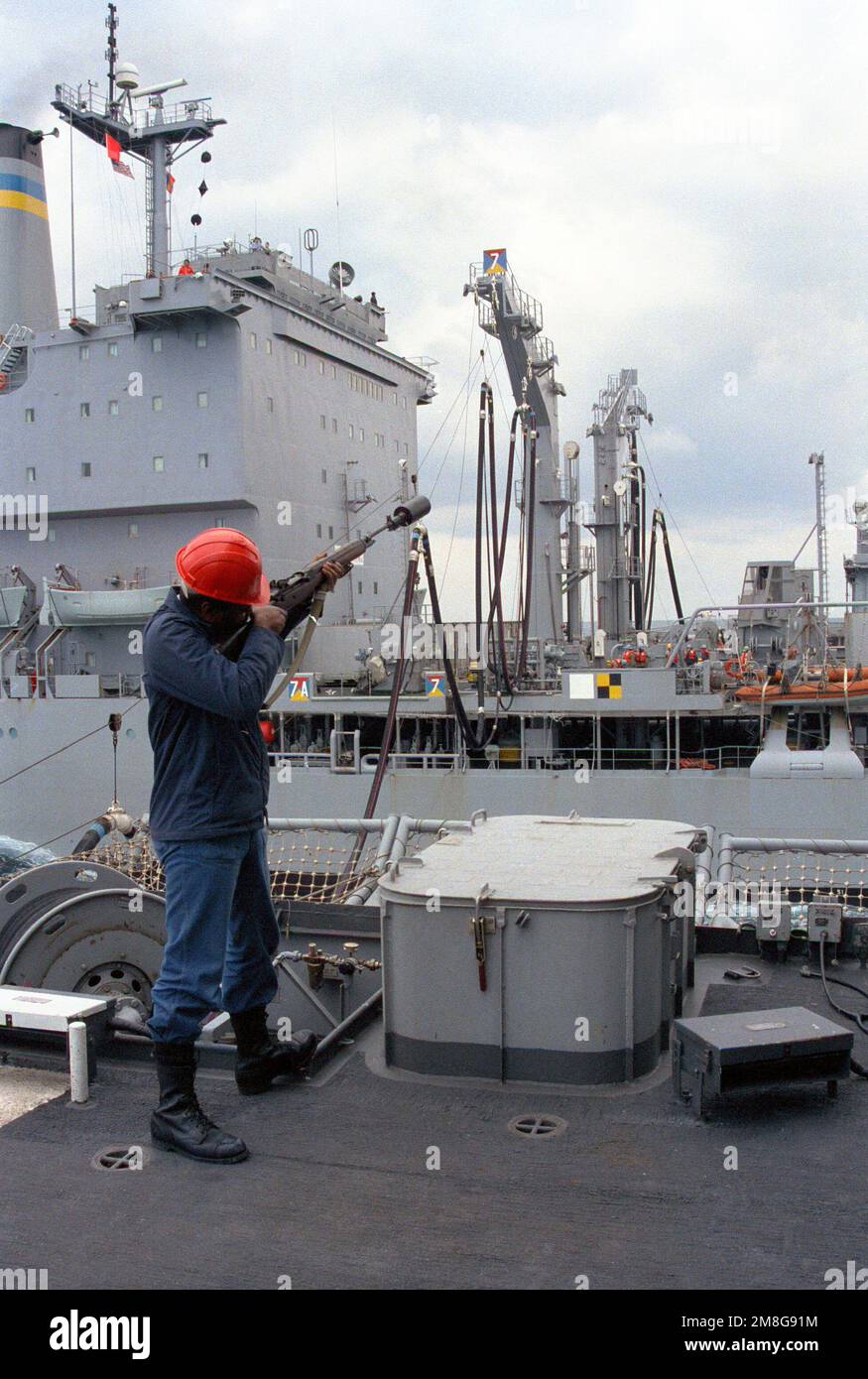 During a replenishment at sea (RAS), a sailor from the guided missile ...
