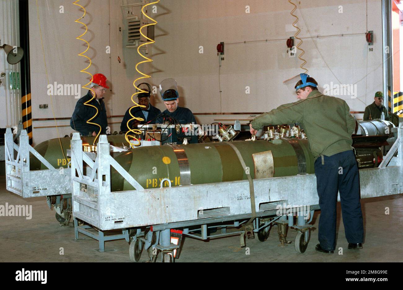 Mineman install firing mechanisms on a Mark 64 Quickstrike mine. Naval ...