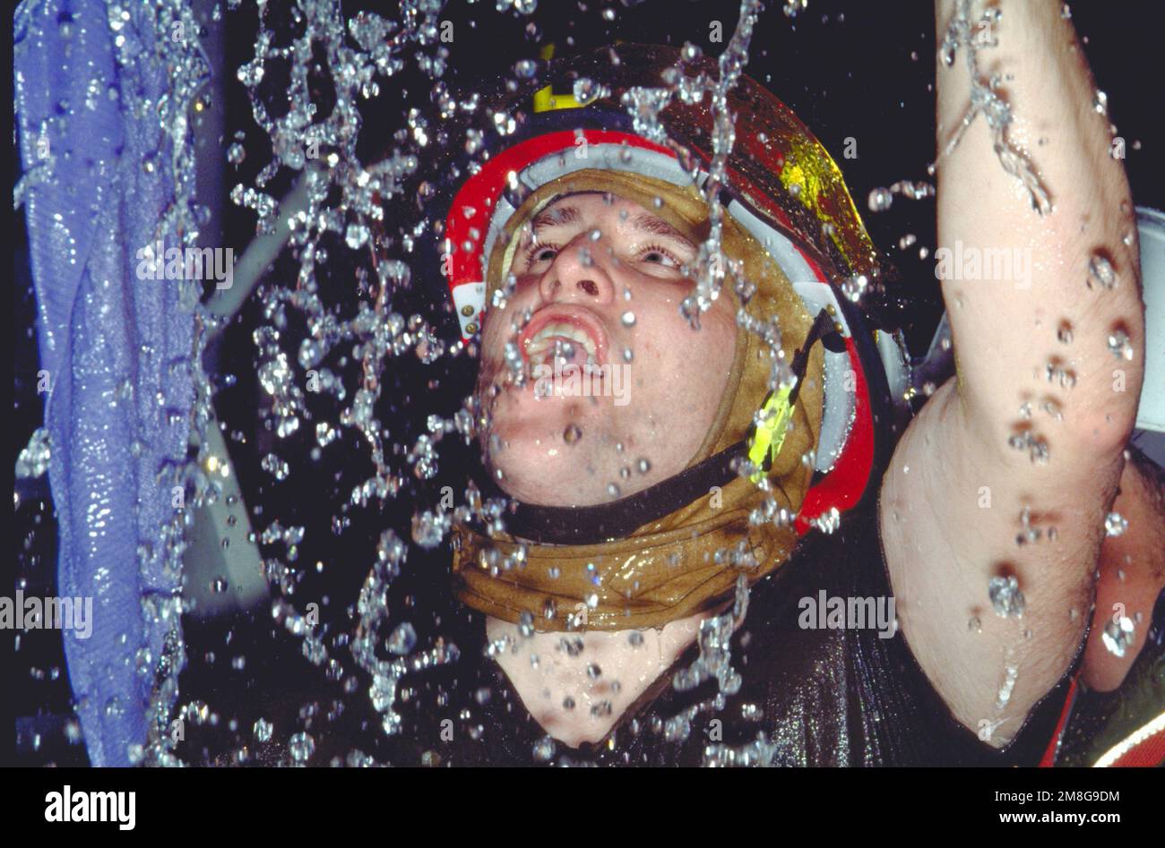 Water pours on a trainee as he attempts to shore up a hole to fix the ...