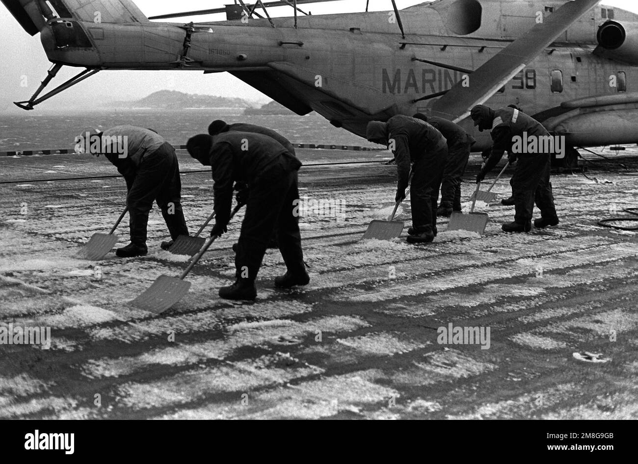 Flight deck personnel of the amphibious assault ship USS GUADALCANAL ...
