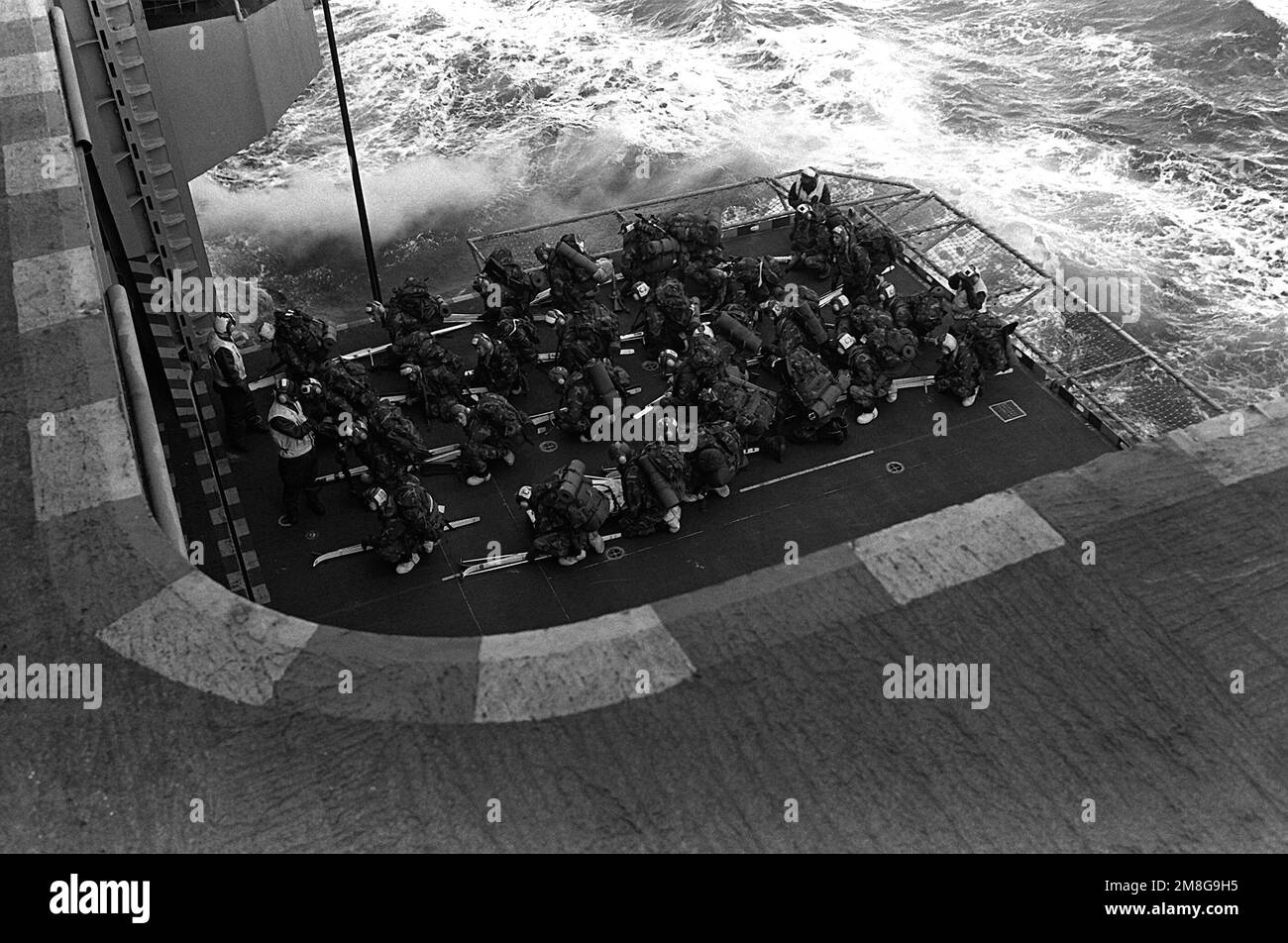 U.S. Marines carrying snow ski's and other alpine gear ride up to the ...