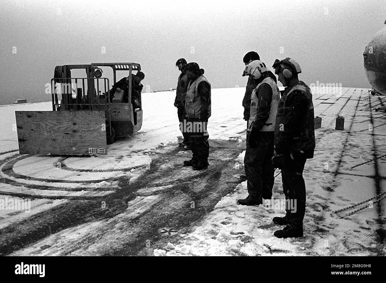 Members of the deck force of the amphibious assault ship USS ...