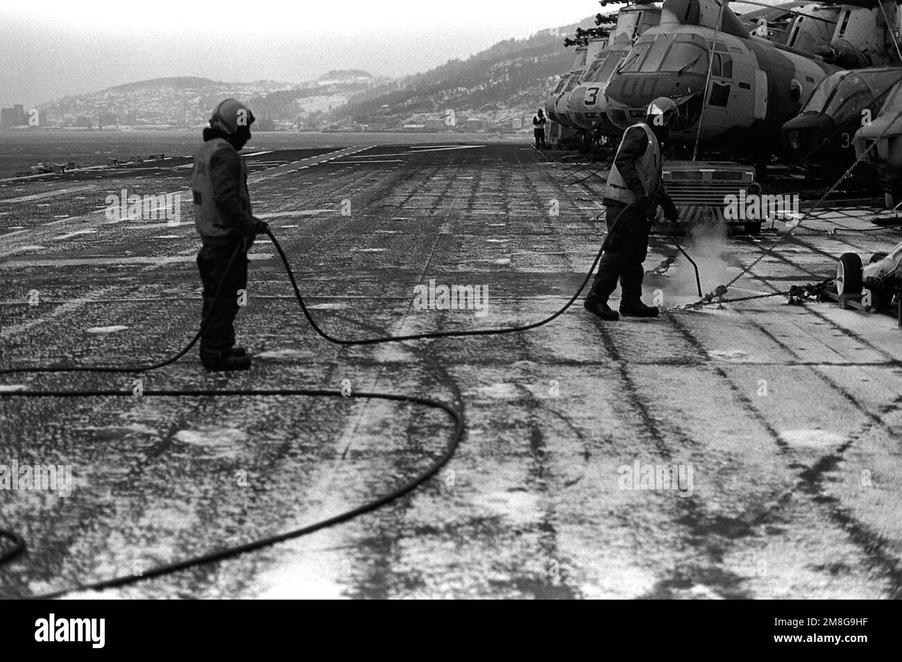 Flight deck personnel of the amphibious assault ship USS GUADALCANAL ...