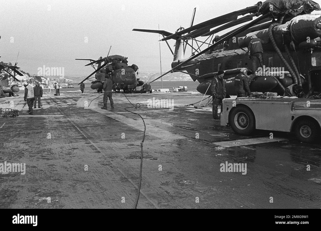 Flight deck personnel are preparing the flight deck of the amphibious ...