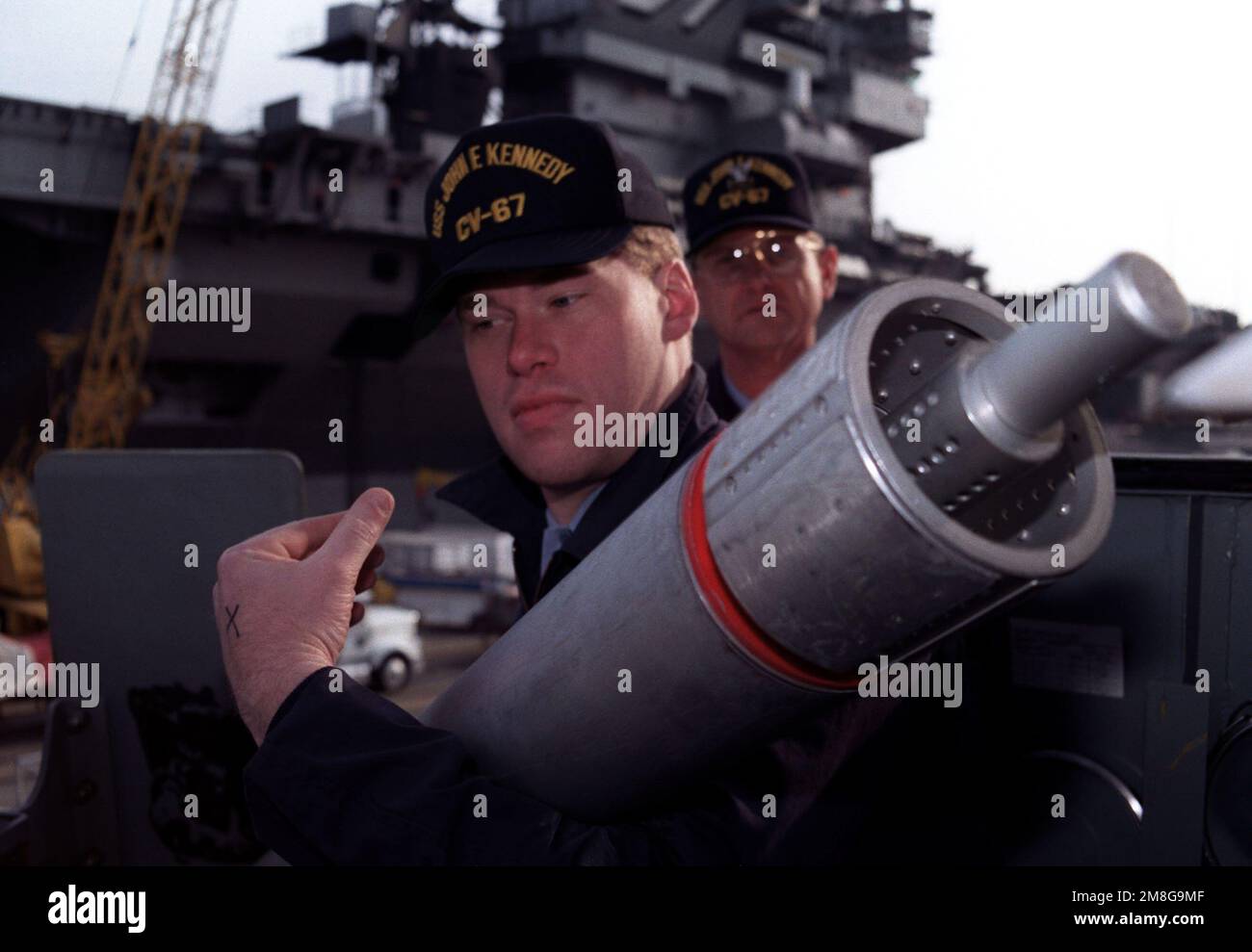 A sailor from the Super Rapid Bloom Offboard Chaff (SRBOC) reloading ...