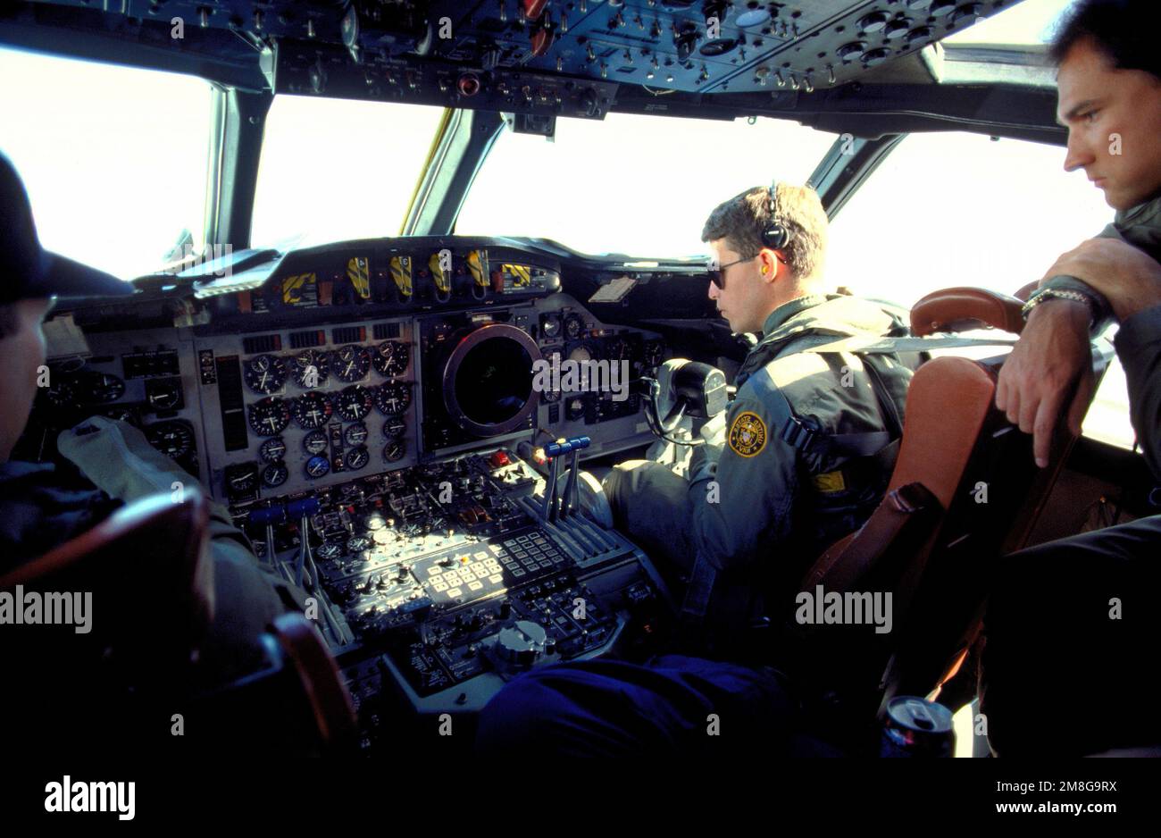 Members of Patrol Squadron 31 (VP-31) monitor controls in the cockpit ...