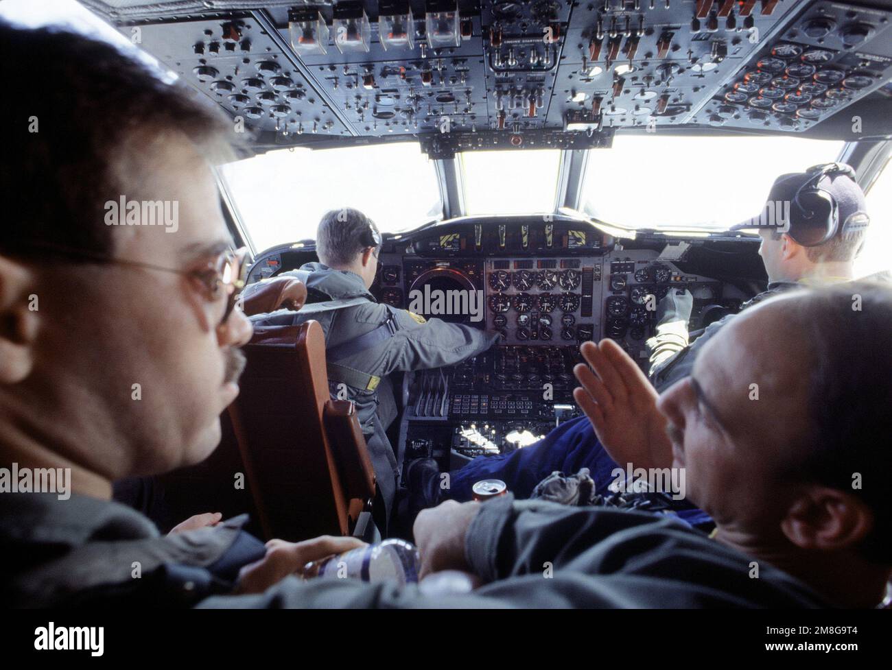 Members of Patrol Squadron 31 (VP-31) monitor controls in the cockpit ...
