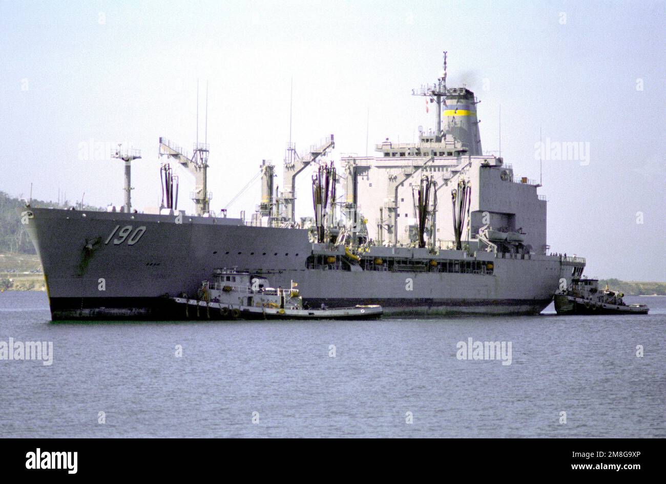 The large harbor tug TAMAQUA (YTB-797) maneuvers the fleet oiler ANDREW ...
