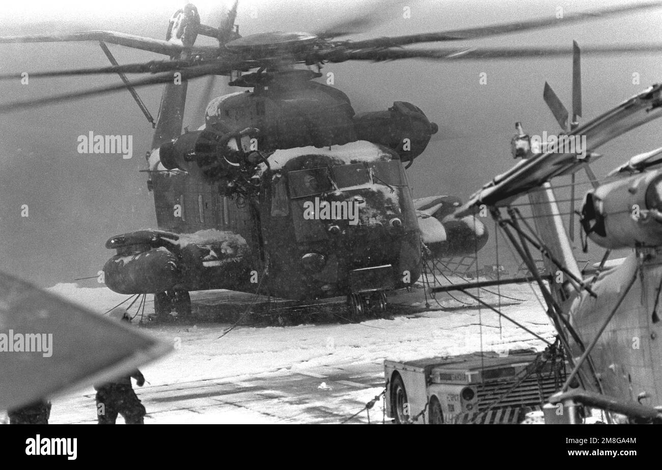 A CH-53E Super Stallion helicopter warms up its engines on the aft ...