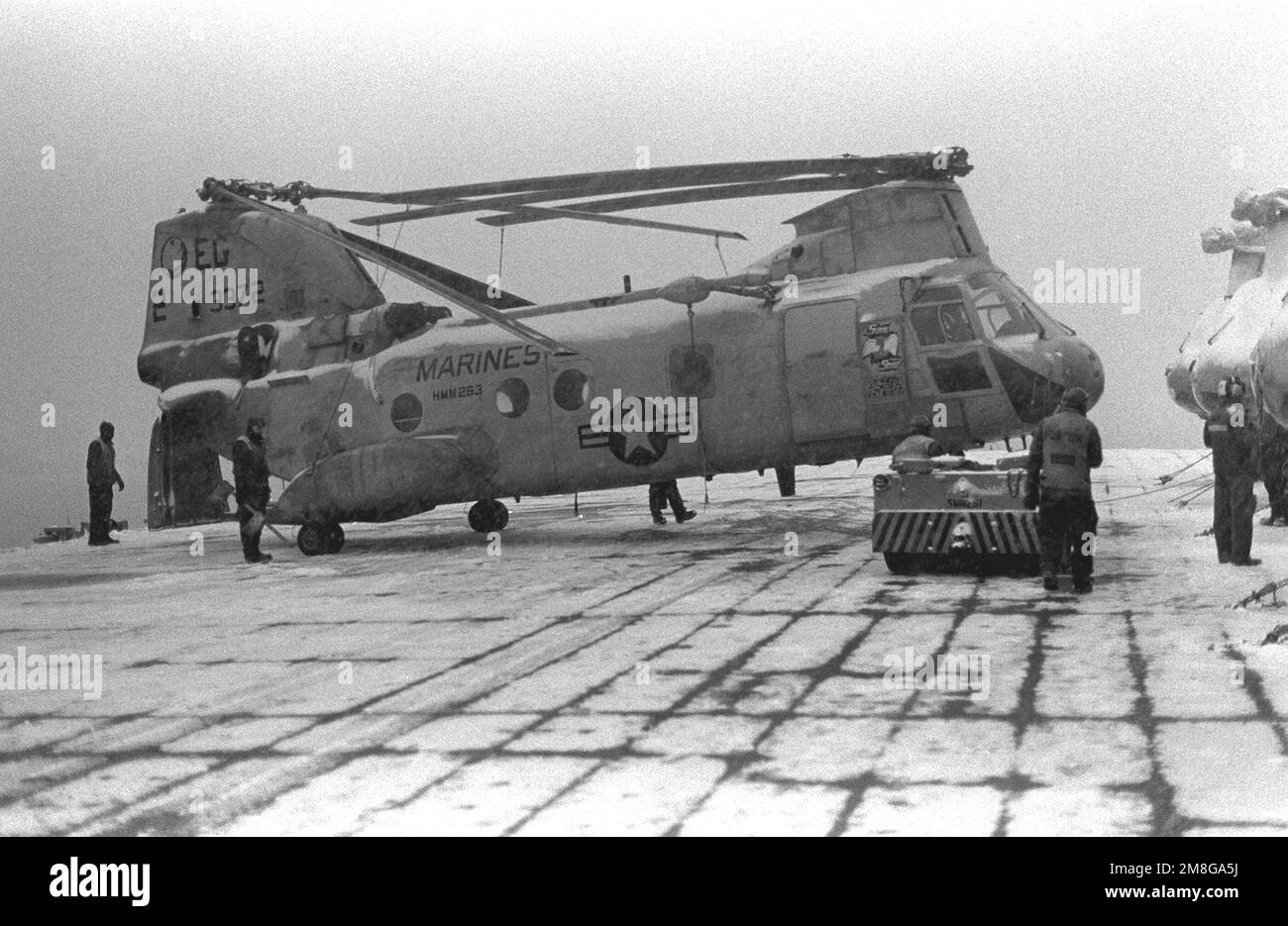 As a new snow storm passes over the amphibious assault ship USS ...